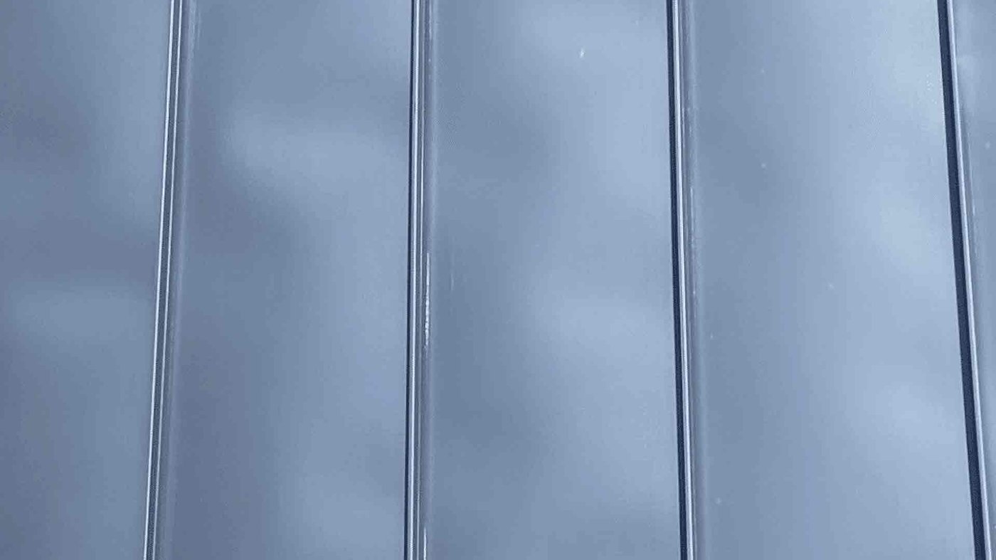 What is Oil Canning? Causes + Solutions For A Common Metal Roof Problem